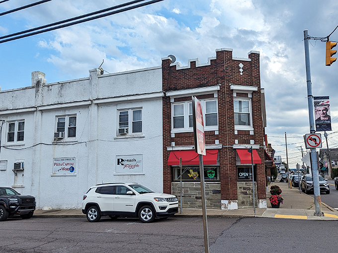 The brick facade and bright red awnings of Revello's stand like a beacon of pizza promise on Old Forge's main drag, beckoning hungry travelers from miles around.