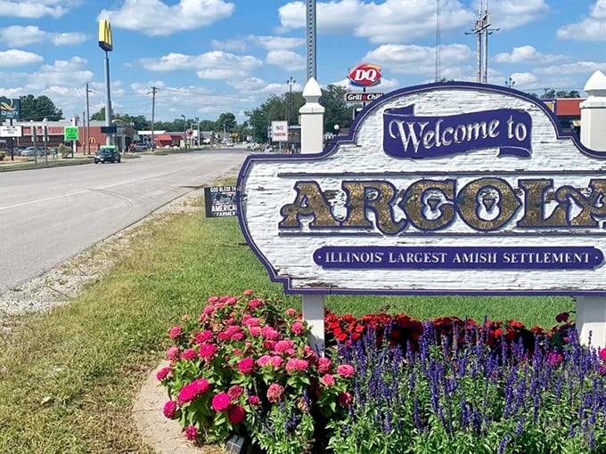The welcome sign says it all – Arcola proudly embraces its Amish heritage while McDonald's and DQ stand nearby, a perfect metaphor for this charmingly contradictory town.