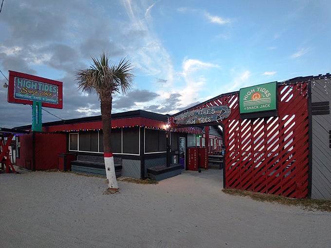 The iconic red exterior of High Tides at Snack Jack stands as a beacon of hope for hungry beachgoers, promising seafood salvation just steps from the Atlantic.