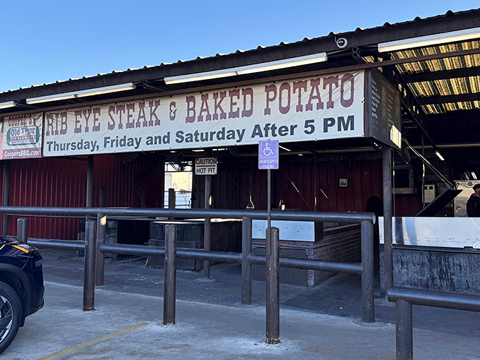 The iconic red exterior of Cooper's Old Time Pit Bar-B-Que stands like a beacon to meat lovers across Texas Hill Country.