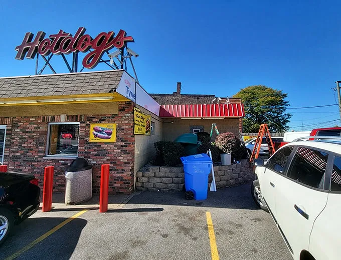 The bright yellow sign beckons like a lighthouse for the hungry—where being "in the dog house" is actually the goal, not the punishment.