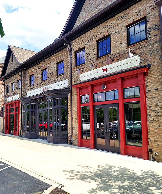 The brick façade with those eye-catching red doorframes isn't just inviting—it's practically shouting "Get in here and eat something amazing!"