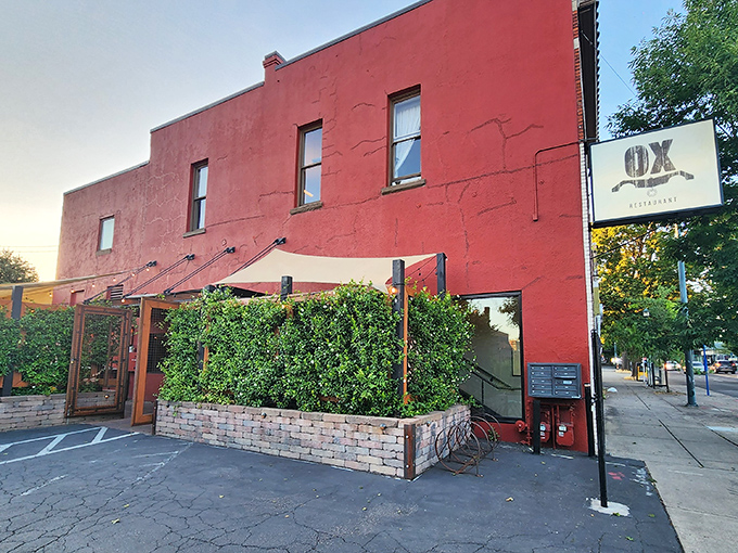 The bold red exterior of Ox Restaurant stands like a carnivore's lighthouse, beckoning hungry Portlanders with promises of flame-kissed delights.