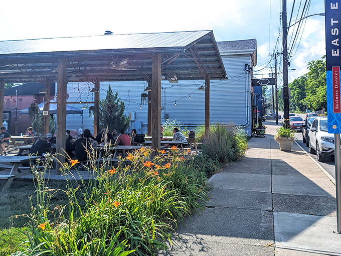 The covered patio at Eli's BBQ is where summer memories are made, with wildflowers nodding hello as smoke wafts through the air.