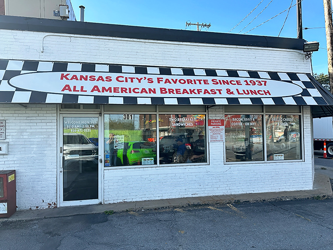The classic black-and-white checkered awning isn't just decoration—it's a beacon calling hungry souls to breakfast paradise on Grand Boulevard.