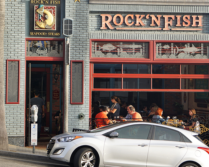 The iconic blue-and-red façade of Rock'n Fish beckons seafood lovers like a maritime lighthouse, promising delicious treasures within just steps from Manhattan Beach Pier.