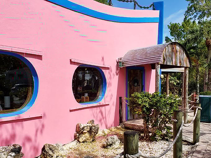 That pink exterior isn't just a building—it's a promise of Florida fun wrapped in Caribbean color. The blue-trimmed windows peek out like portholes on this seafood sanctuary.