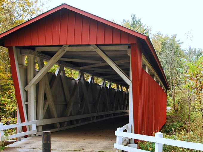 The classic red exterior with white trim isn't just for show—these colors helped protect the wood while making the bridge visible to approaching travelers.