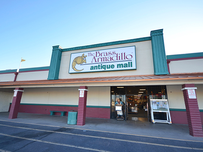 The teal-trimmed facade of Brass Armadillo beckons like a siren song to vintage lovers. This unassuming exterior hides a treasure trove within.