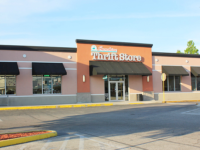 The coral-colored facade of Sunshine Thrift Store beckons bargain hunters like a retail oasis in the Florida sun.