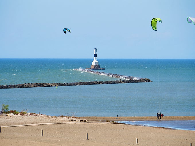 The iconic lighthouse stands sentinel at the end of the breakwall, while colorful kites dance above Lake Erie's surprisingly Caribbean-blue waters.