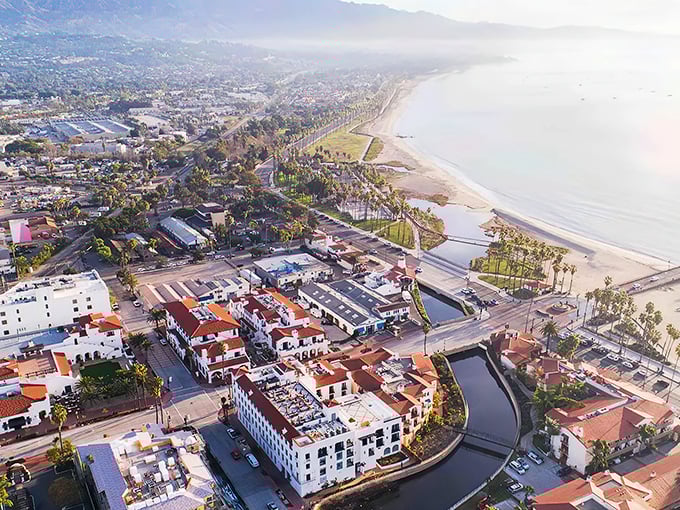 Port Hueneme's aerial view reveals what developers dream about at night—pristine beaches, Spanish-style architecture, and that perfect California coastline stretching into misty mountains.