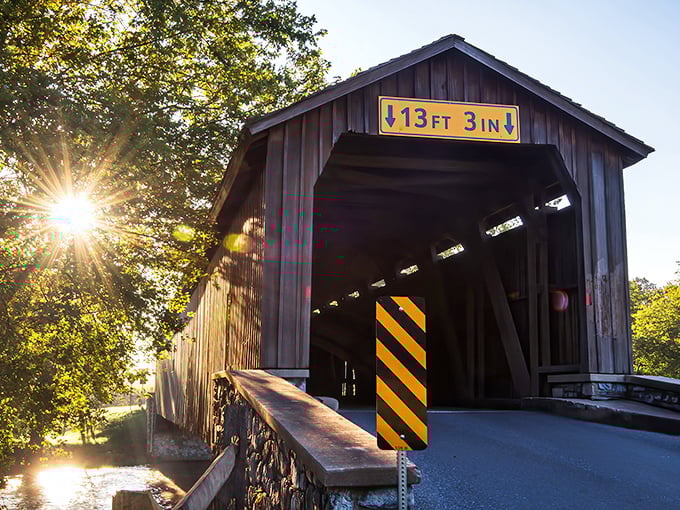 Time stands still at Hunsecker's Mill Covered Bridge, where spring blossoms frame this 180-foot wooden marvel spanning the Conestoga River like a postcard come to life.