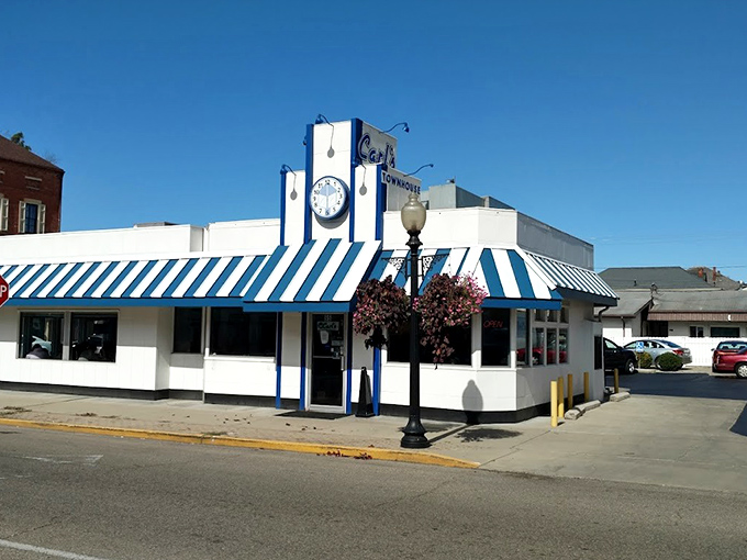 That iconic blue and white awning isn't just eye-catching—it's a time machine disguised as a diner, beckoning hungry travelers with promises of comfort food perfection.