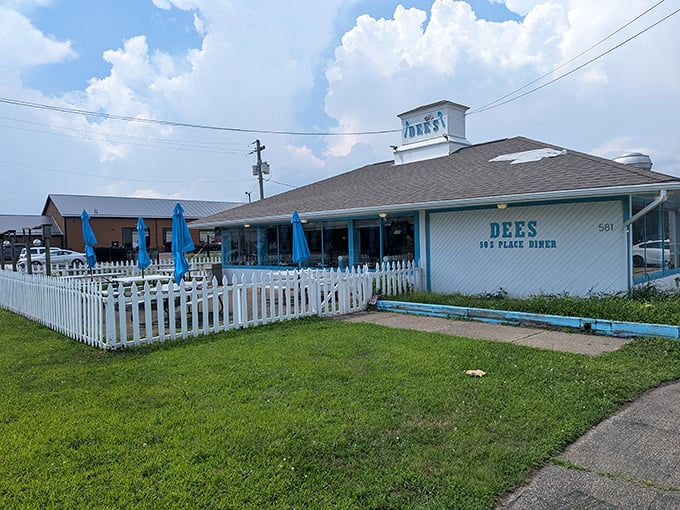 The classic white building with turquoise trim and picket fence patio isn't just charming—it's a time portal to when diners ruled American highways.