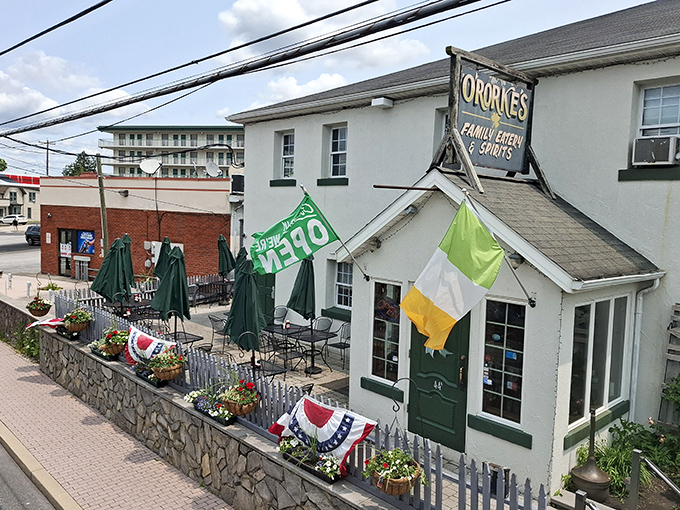The welcoming white exterior of O'Rorke's, where outdoor tables await under folded umbrellas—a perfect spot for people-watching while savoring Gettysburg's flavors.