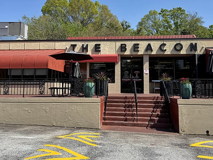 The iconic red awning and stone facade of The Beacon Drive-In stands as Spartanburg's culinary lighthouse, guiding hungry travelers to burger paradise.