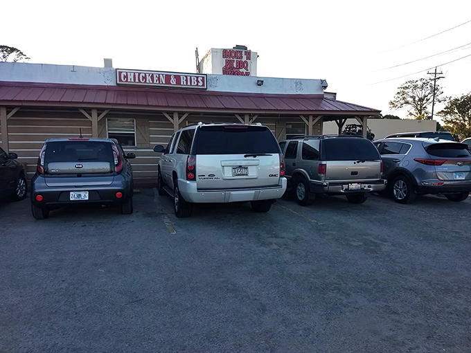 The unassuming wooden exterior of Smoke'n Pit screams "authentic barbecue inside!" Those rooftop signs aren't lying—this place means serious meat business.