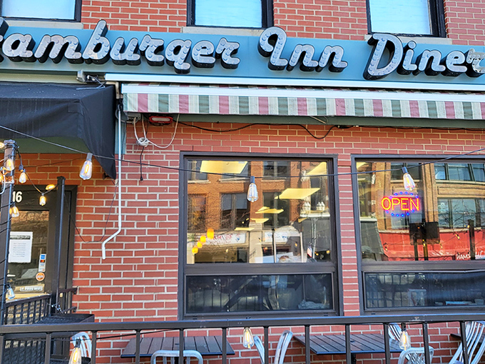 The iconic neon sign of Hamburger Inn Diner beckons hungry travelers like a lighthouse for comfort food enthusiasts navigating downtown Delaware.