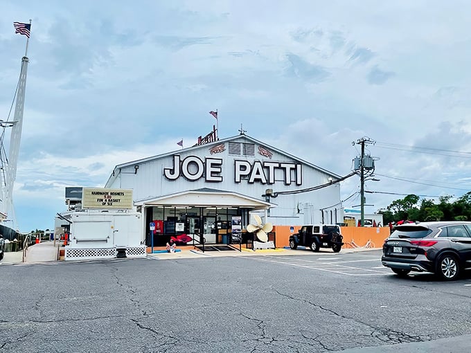 The white building stands like a culinary lighthouse on Pensacola's waterfront, beckoning seafood lovers with its no-nonsense promise of oceanic treasures within.
