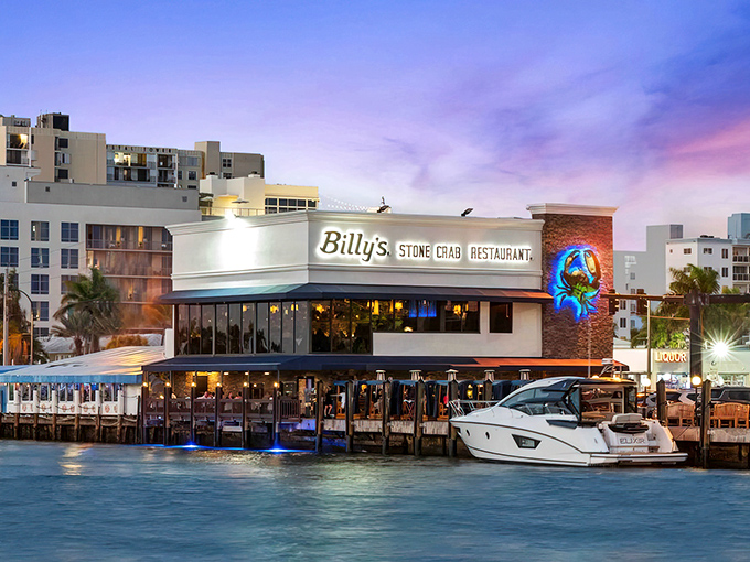 The iconic blue crab emblem welcomes seafood pilgrims to Billy's Stone Crab, standing proud against the Florida sky like a beacon of deliciousness.