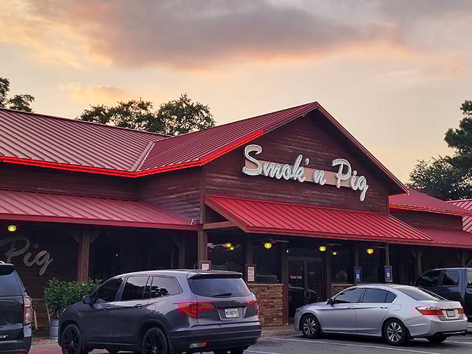 The rustic wooden exterior with its signature red roof isn't just inviting—it's practically a smoke signal to hungry travelers passing through Valdosta.