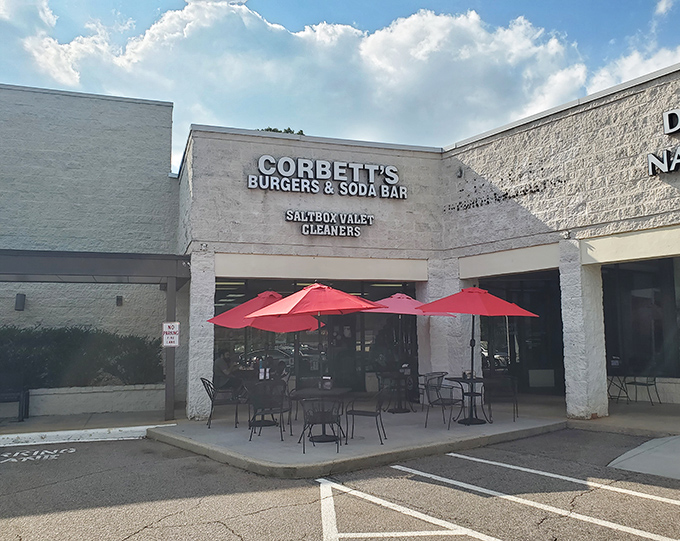 Unassuming strip mall treasure with bright red umbrellas beckoning you in—proof that culinary gems often hide in plain sight.