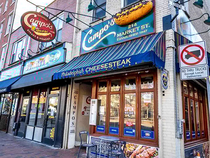 The iconic blue awning of Campo's beckons hungry pilgrims like a culinary lighthouse on Market Street, promising cheesesteak salvation to all who enter.