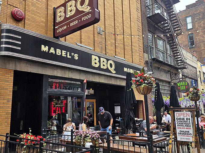 The brick façade of Mabel's BBQ beckons from East 4th Street like a smoky siren song. Cleveland's barbecue haven awaits behind those doors.