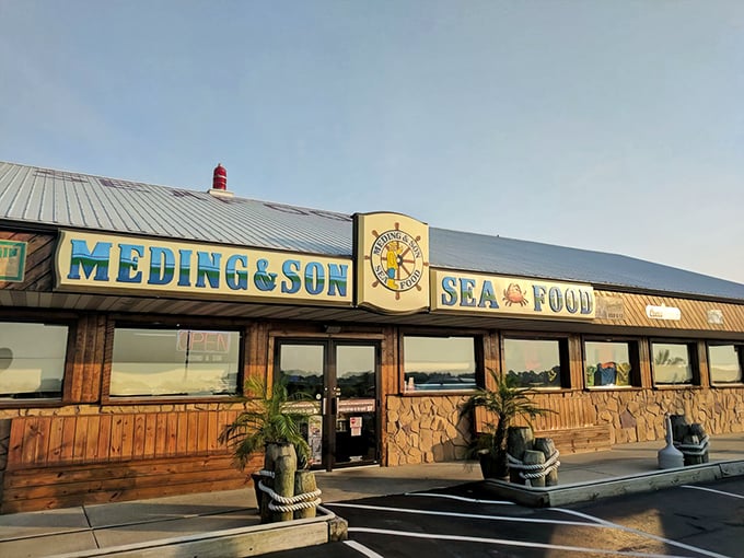 The unassuming exterior of Meding's Seafood beckons like a lighthouse for hungry travelers. That blue sign promises seafood salvation just off the highway. 