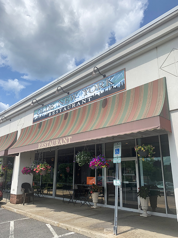 The unassuming storefront with its cheerful hanging flower baskets feels like a secret you've stumbled upon—the best kind of culinary discovery awaits inside.