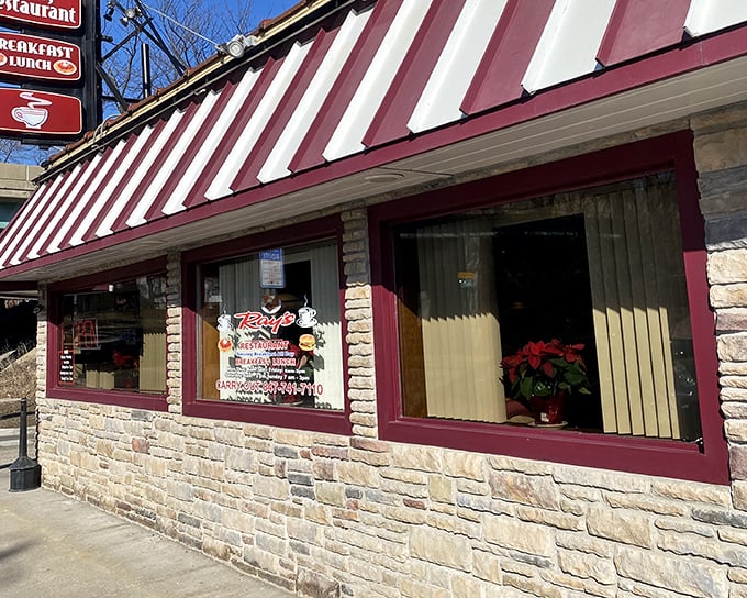 The red and white awning of Ray's Diner beckons like a lighthouse for hungry souls navigating the streets of Elgin. Classic stone exterior promises timeless comfort within.