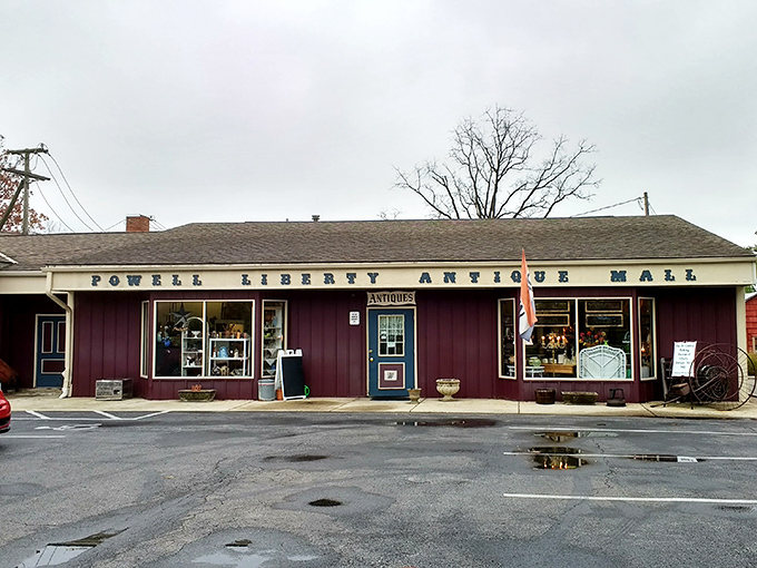 The unassuming burgundy exterior of Powell Liberty Antique Mall promises treasures within, like a vintage jewelry box waiting to be opened.