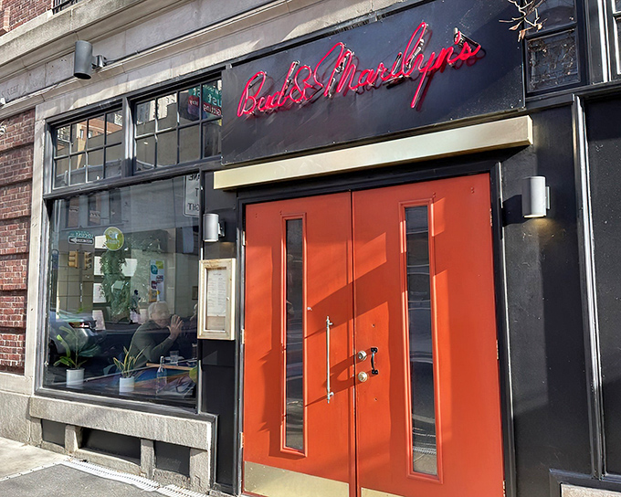 Those iconic red doors aren't just an entrance – they're a portal to comfort food paradise. Bud & Marilyn's neon sign glows like a beacon for hungry Philadelphians.