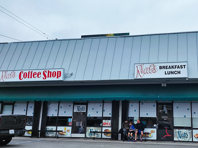The unassuming exterior of Nat's Early Bite – where breakfast dreams come true behind a modest teal awning and zero pretension.