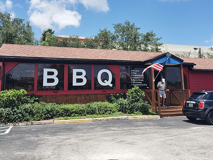 The red building with "BBQ" boldly displayed isn't just announcing its presence—it's making a solemn promise your taste buds won't soon forget.