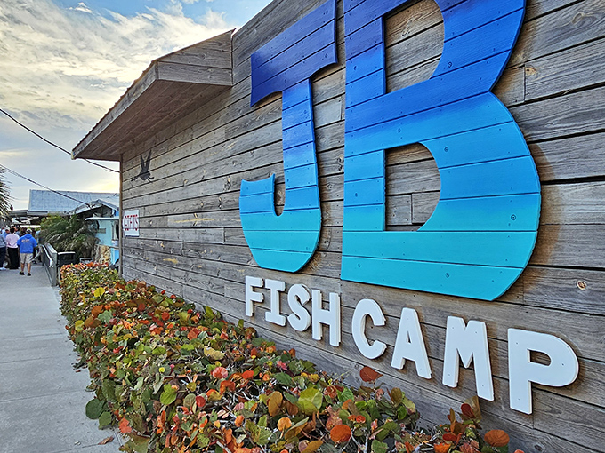The weathered wooden exterior with its gradient blue "JB" sign isn't trying to impress anyone—which is exactly how you know the food inside will be spectacular.