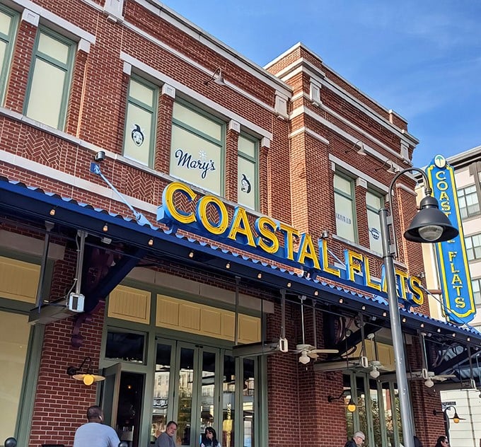 Coastal Flats glows like a beacon at twilight, its brick façade and blue awnings promising seafood salvation in suburban Maryland.