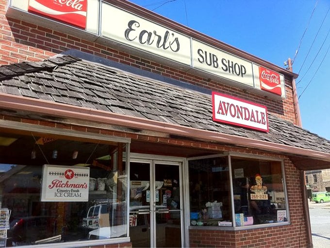 Earl's Sub Shop at sunset – where the humble brick exterior and vintage Coca-Cola signs promise authentic deliciousness that transcends the modest surroundings.