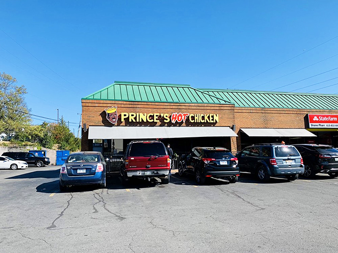 The brick facade of Prince's Hot Chicken Shack South stands like a temple to spice, beckoning heat-seekers with its iconic crown logo and fiery promise.