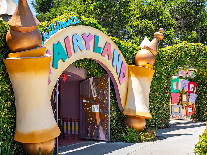 The Old Woman's Shoe House stands like a golden beacon of childhood wonder, complete with teal roof and whimsical charm that defies architectural logic.