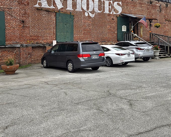 The brick exterior of Payne Mill Village Antique Mall stands like a time capsule waiting to be opened, complete with those magnificent green doors that practically whisper "treasures inside."