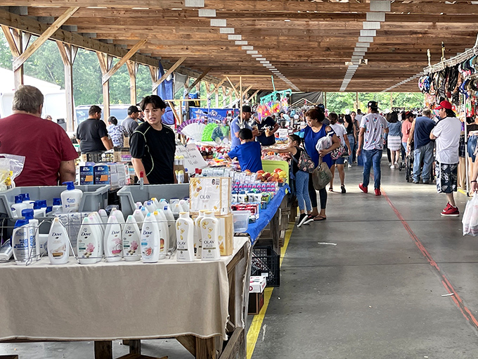 The covered walkways of Webb Road Flea Market stretch into the distance like a treasure hunter's yellow brick road. Every table holds potential discoveries!
