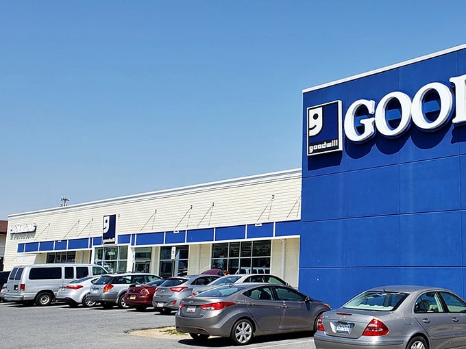 The blue and white facade of Ellicott City's Goodwill stands like a beacon of bargain possibilities, promising treasures within its unassuming exterior.