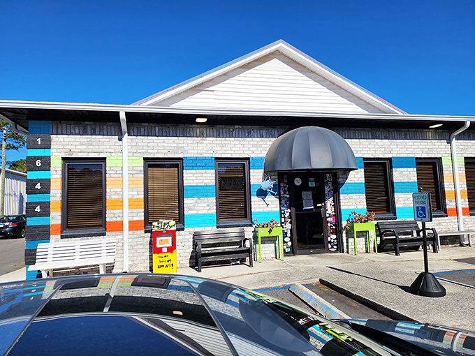 The colorful exterior of Early Bird Diner beckons like a rainbow after a Charleston rainstorm. Those vibrant stripes aren't just decoration—they're a promise of the personality waiting inside.