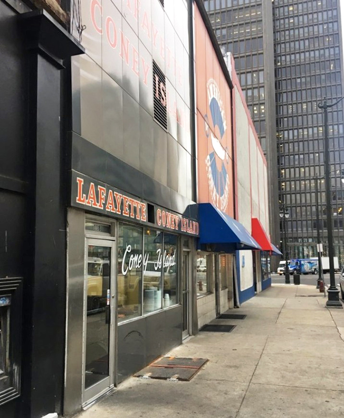 The iconic facade of Lafayette Coney Island stands proudly next to its rival, American. Detroit's culinary cold war continues deliciously on this corner.