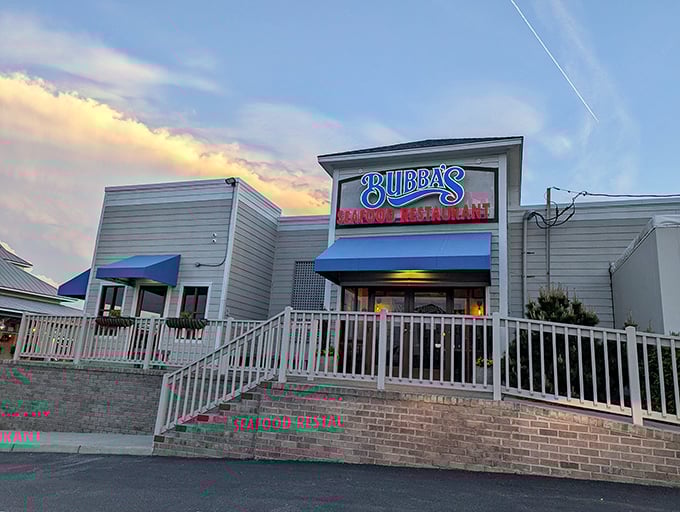 Bubba's welcomes you with that perfect coastal charm – a blue-awninged beacon of seafood promise against a golden Virginia Beach sunset.