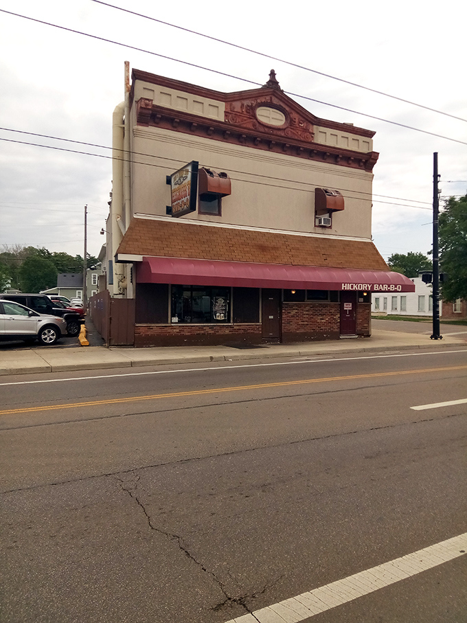 The iconic burgundy awning of Hickory Bar-B-Q stands as a beacon of smoky promise on this Dayton corner. Barbecue salvation awaits inside.