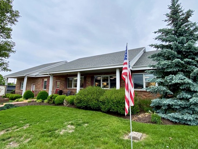 The unassuming brick exterior of Bill's Donut Shop stands like a temple to fried dough, complete with American flag – patriotism never tasted so sweet.