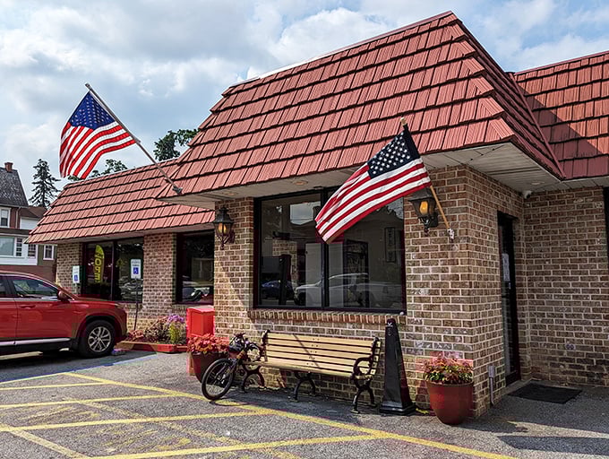 The iconic red-roofed brick building with American flags proudly waving says everything you need to know—comfort food and patriotism served in equal measure.
